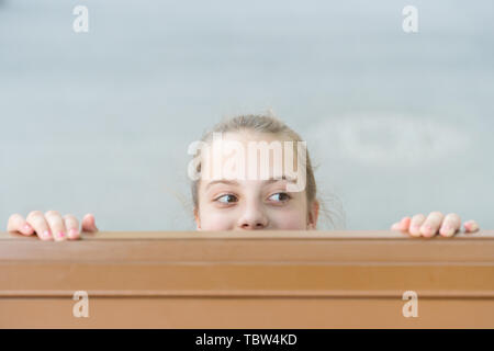 Secret place for hiding. Cute small child hiding under the table ...