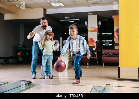Family playing bowling in club Stock Photo - Alamy