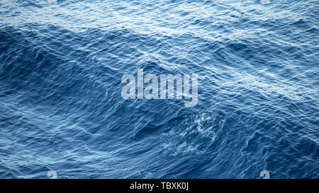 Glistening and shimmering blue ocean surface background with sun ...