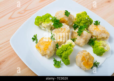 Fish balls of different white fish at plate with brokkoli, dish of ...