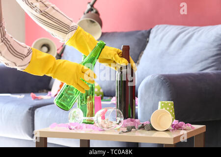 Cleaning of room in terrible mess after party Stock Photo - Alamy