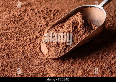 Metal scoop on cocoa powder Stock Photo - Alamy