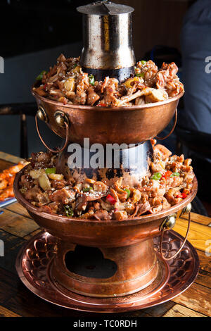 Charcoal fire frog pot field chicken meal Stock Photo - Alamy
