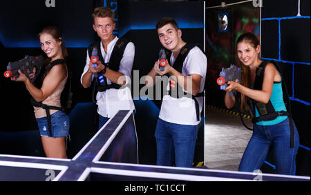 Group cheerful people playing laser tag game Stock Photo - Alamy