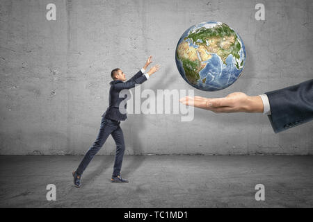 Hand emerging from the earth Stock Photo - Alamy