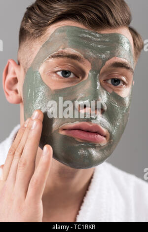 sad young man touching clay mask isolated on grey Stock Photo - Alamy