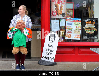 Shopkeeper Kathleen Whelan poses with a mannequin of Donald Trump, as ...