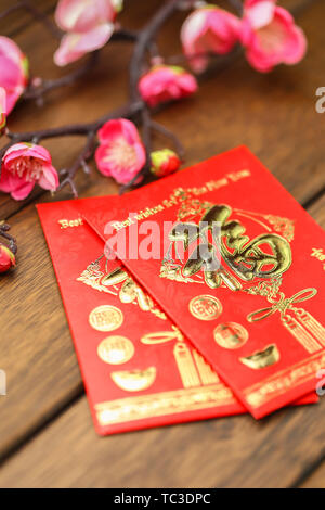 Spring Festival red envelopes on wooden table Stock Photo - Alamy
