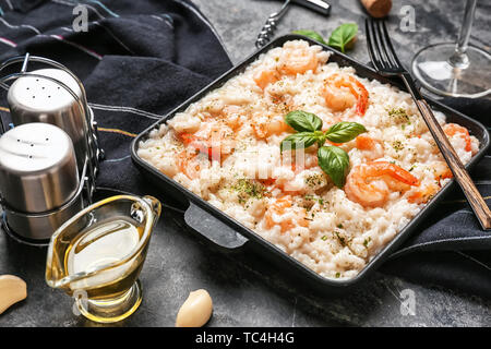 Frying pan with tasty risotto on table Stock Photo - Alamy