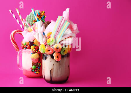 Different delicious freak shakes on colorful background Stock Photo - Alamy