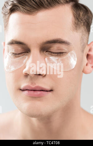 A handsome young man with eye patches on his eyes Stock Photo - Alamy