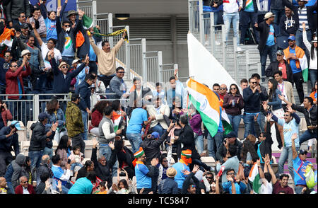 A fan catches the ball during the World Cup Group L soccer match ...
