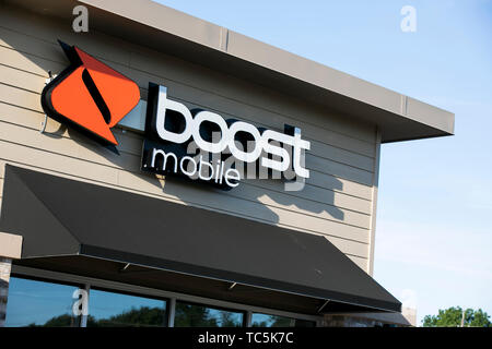 A logo sign outside of a Boost Mobile retail store location in ...