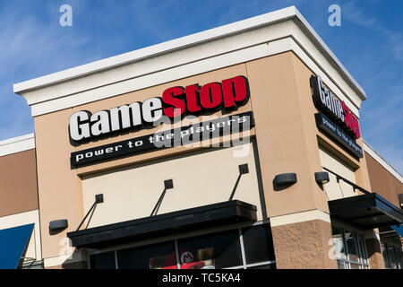 A logo sign outside of a GameStop retail store location in Martinsburg ...