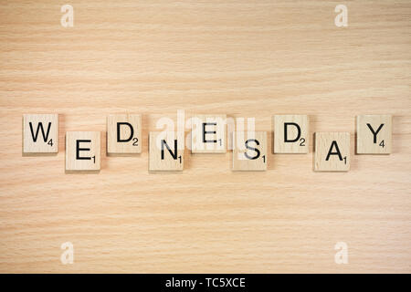 The word Wednesday, spelt out using wooden tiles on a wood effect ...