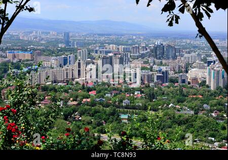 Almaty city view from Kok-tobe Mountain at dramatic stormy sunset sky ...