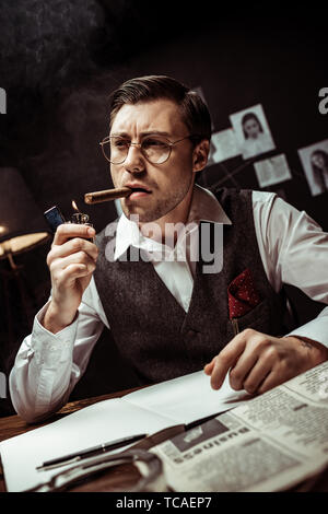 Professional detective smoking cigarette in his office Stock Photo - Alamy