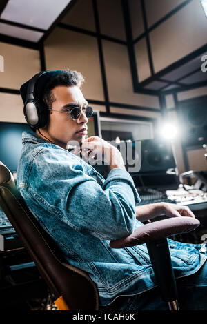 Serious man sitting in recording studio Stock Photo - Alamy