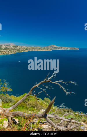 The vertical view of the sea watchtower in the water under the blue sky ...