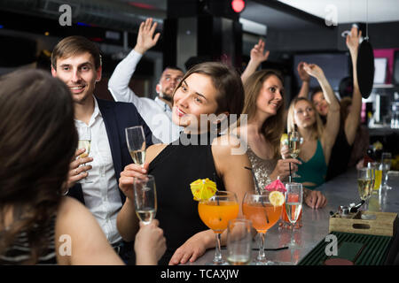Female office worker is drinking cocktails with colleague at corporate ...