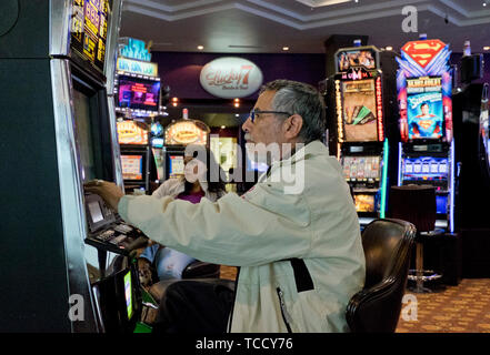 Elderly customers gambling at slot machines at a casino in Puerto Varas ...