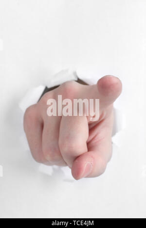 Pointing hand breaking through the paper Stock Photo - Alamy