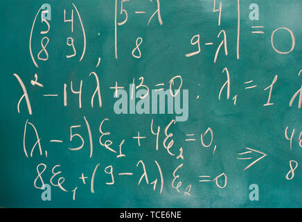 formulas written on green chalkboard Stock Photo - Alamy