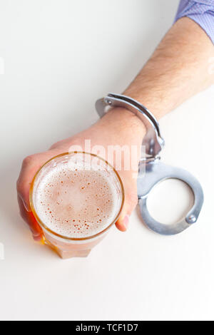 Glass of beer with handcuffs as symbol for alcohol abuse Stock Photo ...