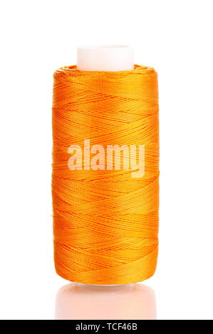 Orange bobbin thread isolated on white Stock Photo - Alamy