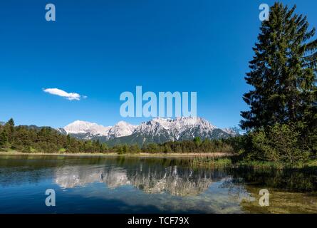 Western Karwendelspitze is reflected in Lake Luttensee, Karwendel ...
