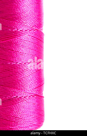 Pink bobbin thread isolated on white Stock Photo - Alamy