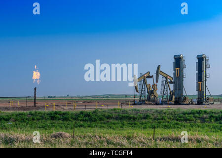 Natural gas flaring and a pumper in the Bakken shale oil fields near ...