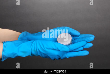 Uranium in hands on grey background Stock Photo - Alamy