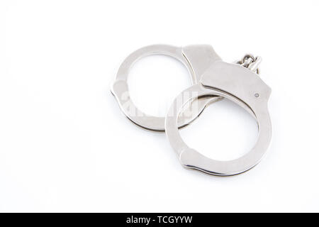 Shiny metal chrome handcuffs on a white background Stock Photo - Alamy