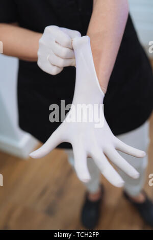doctor's hand in white sterilized surgical glove holding medicine Stock ...