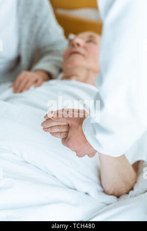 Coma patient. Woman near her unconscious mother in hospital Stock Photo ...