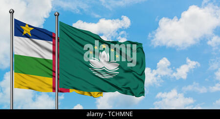 Flagpole with the flag of Macau against the sky and behind a fence with ...