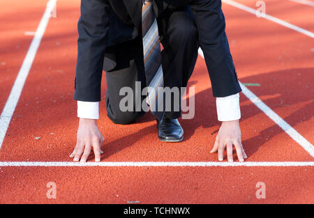 Business man waiting for start signal to run on the competition running ...