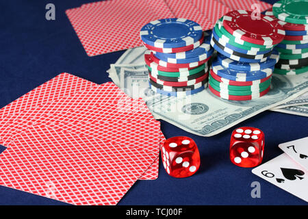 The blue poker table with cigars, poker chips, playing cards and ...