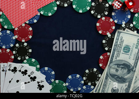 frame made of poker chips, playing cards and dollars on the blue ...