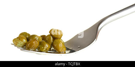 green capers in metal fork on white background close-up Stock Photo - Alamy