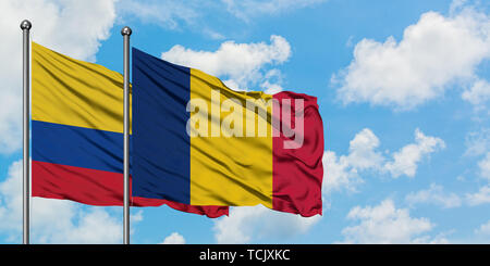 Chad and Colombia flag waving in the wind against white cloudy blue sky ...