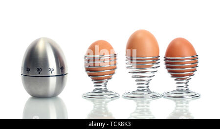 egg timer and egg in metal stand isolated on white Stock Photo - Alamy