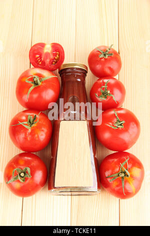 Ketchup in bottle and tomatoes on wooden table Stock Photo - Alamy