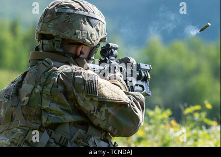 U.S. Army soldiers fire an M4 rifle during a night fire exercise for ...