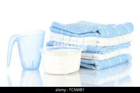 measuring cups with washing powder and towels, isolated on white Stock ...