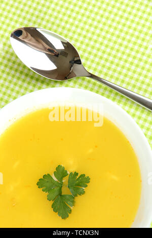 Fragrant soup in white plate on table on window background close-up ...