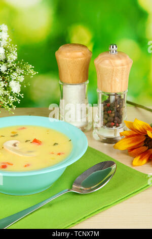 Fragrant soup in blue bowl with ingredients around on table close-up ...