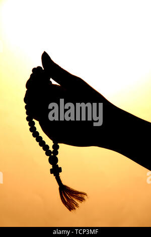female hands with rosary, on beige background Stock Photo - Alamy