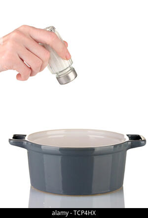 Hand adding salt using salt shaker on bright background Stock Photo - Alamy